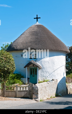 A round house at Veryan Cornwall UK reflected in the window of it s ...