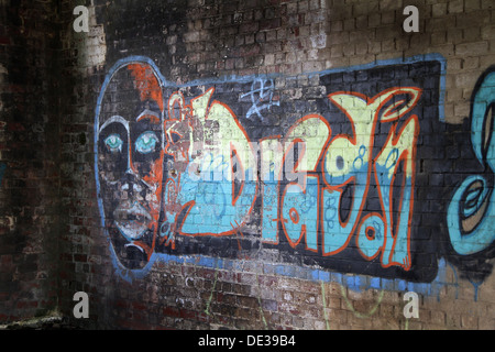 Graffiti on inside walls of old derelict engineering building Stock ...