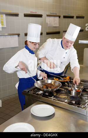 Moers, Germany, Trainee Koechin and cooking Stock Photo - Alamy