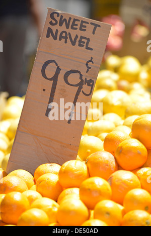 Close up of fresh oranges with price tag and type label on a stall ...