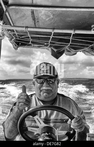 A deep-sea fishing boat captain displays all of the fish his ...