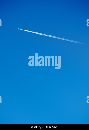 airplane contrail on blue sky Stock Photo - Alamy