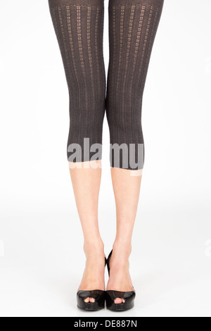 Long Slim legs wearing colorful leggins on plain background Stock Photo ...