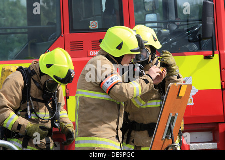 Firefighters checking breathing apparatus during a training exercise ...