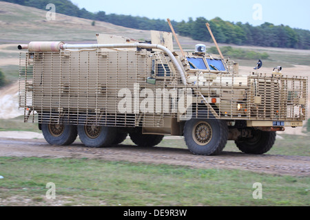 Army Mastiff armoured patrol vehicle driving over rough terrain during ...