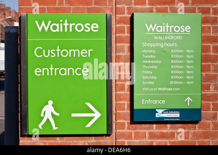 Waitrose opening hours sign Stock Photo - Alamy