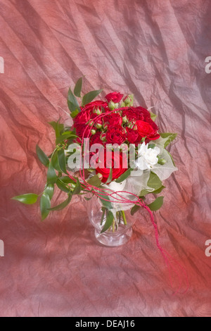 Red roses flower bouquet on white stone table. Top view with copy space ...