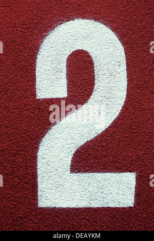 Number two. Big white track number on red rubber racetrack. Gentle ...