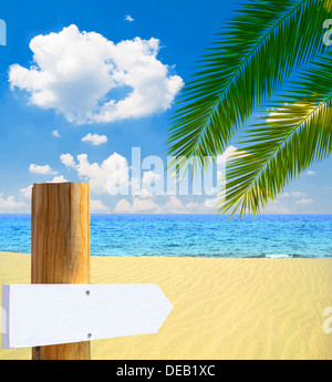 Paradise beach with empty wooden sign Stock Photo - Alamy