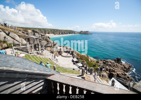 PORTHCURNO, CORNWALL, ENGLAND - July 25: Woman in red stands looking ...