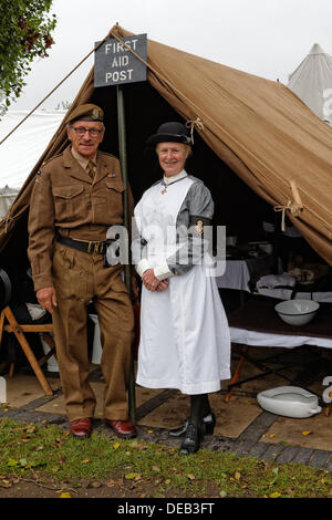 A VAD (Voluntary Aid Detachment) nurse taking care of injured men at a ...
