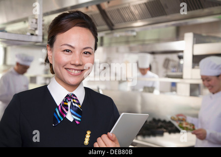 Restaurant Hostess in an Industrial Kitchen Stock Photo - Alamy