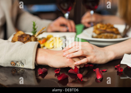 Loving couple holding hands in car close-up Stock Photo - Alamy