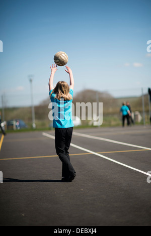 Pre-teen children pupils playing games at breaktime in a primary school ...