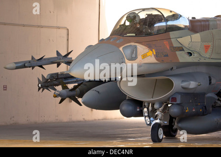 An Israeli pilot with a F-16 fighter jet in a hangar at Hatzor Israeli ...