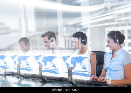 Call center employees at work on futuristic interfaces showing map and ...