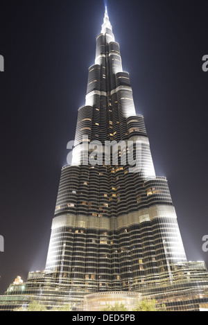 Burj Khalifa, with 828m height the tallest tower in the world, and palm trees at night, Dubai ...