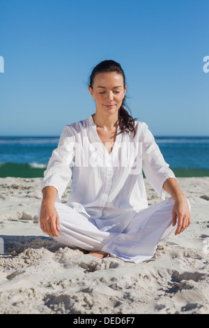 Beautiful woman with blue eyes sitting on wheelchair covering eyes with ...