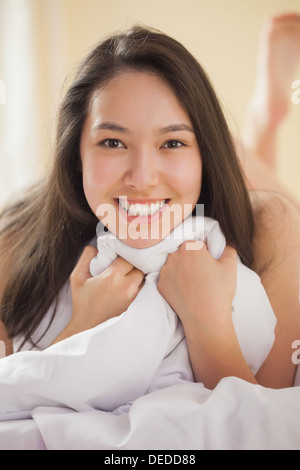 Young cute smiling asian woman writing notes in cozy spacious living ...