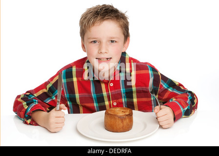 Boy eating pork pie. Studio white background Stock Photo - Alamy