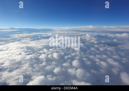 Aerial view from high altitude of earth covered with puffy rainy clouds ...