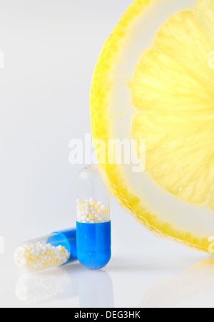 Close up of fresh lemon and pills isolated – vitamin concept - white ...