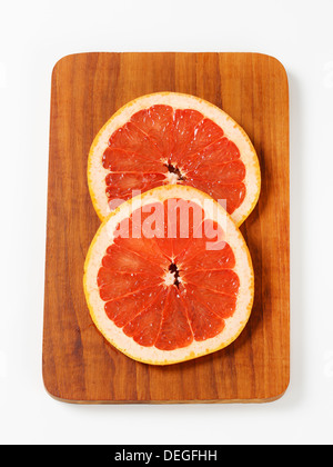 Slices of Ruby Grapefruit on white background Stock Photo - Alamy