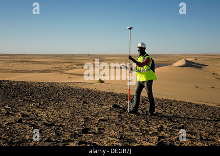 Geological surveyor using differential GPS equipment for a digital ...