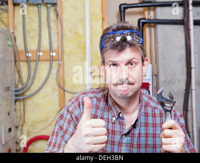 Portrait of happy handyman holding wrench Stock Photo - Alamy