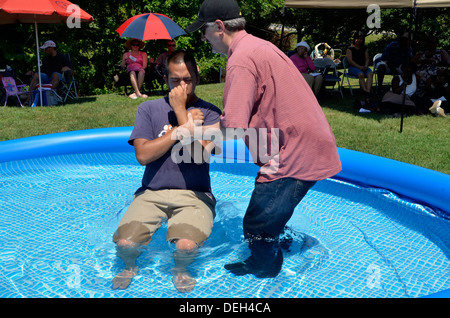 Man gets baptized at an outdoor baptism Stock Photo - Alamy