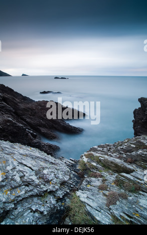 Rocky seascape at sunset at Ladies Cove Dartmouth Devon England Stock ...