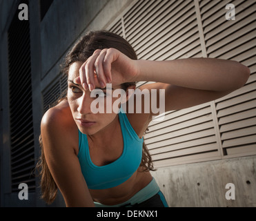 Woman wiping the sweat off her head Stock Photo - Alamy