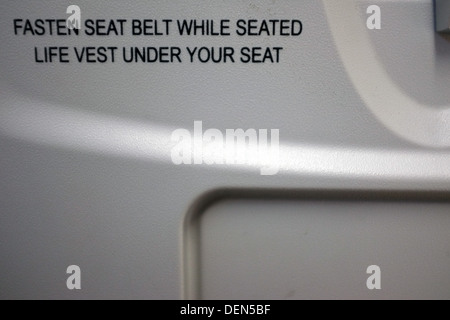 Warning sign on back of airline seat Stock Photo - Alamy