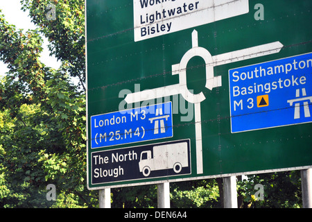 A British roundabout road sign directing traffic to Dorking and South ...
