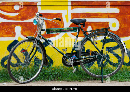 Traditional Indian bicycle against a yellow indian house. Andhra ...