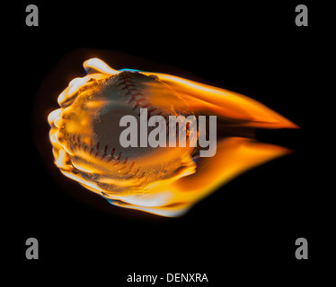 Red hot flaming baseball flying into darkness Stock Photo - Alamy