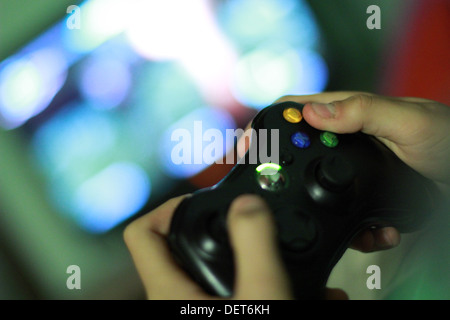 A kid is playing XBOX 360 Stock Photo - Alamy