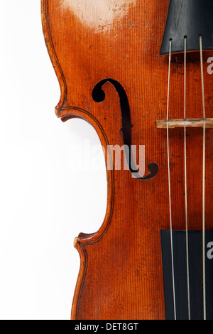 Vertical close up of violin f-hole, fine tuners, strings and bridge in ...