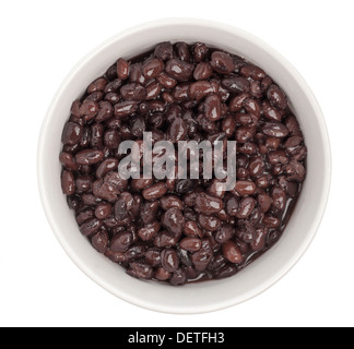 Black beans in white ceramic bowl, surrounded by fresh tomatoes, garlic ...