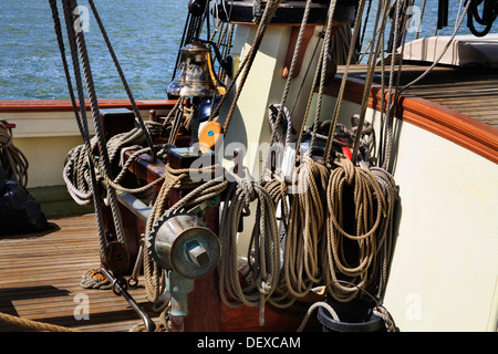 Deck, ropes, rigging and wooden pulleys / blocks on board of sailing ...