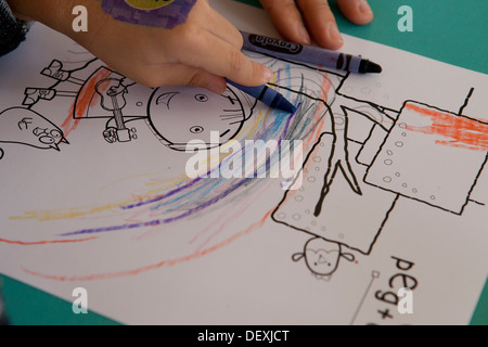 Child drawing on paper with coloring pen. Childhood creative activity ...