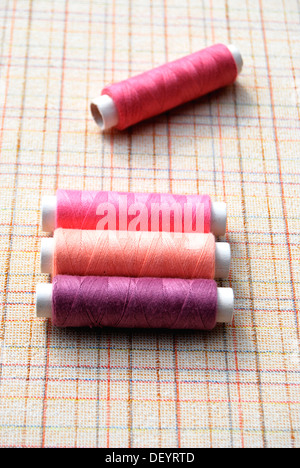 Rows of multi coloured reels of cotton thread used in the creation of ...