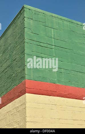 Boldly blocked paint colors of green red and tan on old building Stock ...