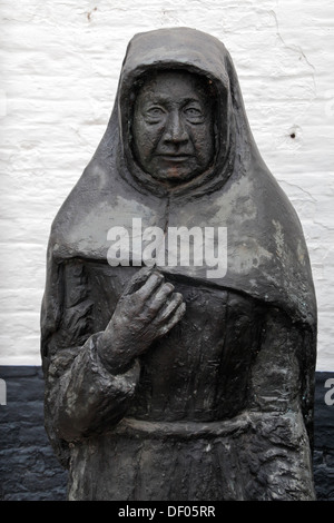 Bronze statue of Beguines (a religious woman) in the UNESCO listed ...