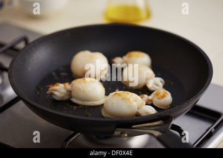 Preparing grilled cuttlefish in a pan close-up Stock Photo - Alamy