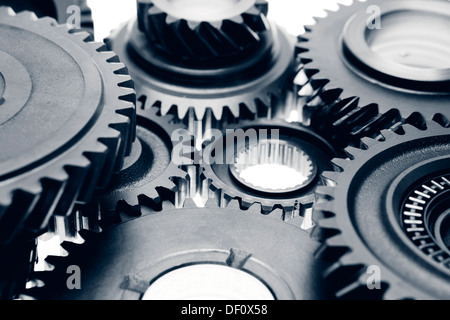 Metal cog wheels bonding together Stock Photo - Alamy