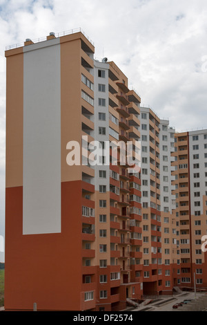 Yellow tall condos and sky Stock Photo - Alamy