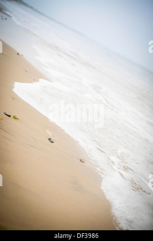 Tide coming in along the coast under a cloudy sky; Tofino, British ...