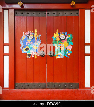 Traditional Chinese menshen, or door gods, decorate the entrance to the ...