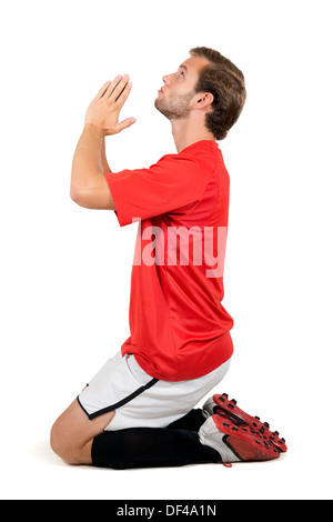 Football player praying isolated in white Stock Photo - Alamy